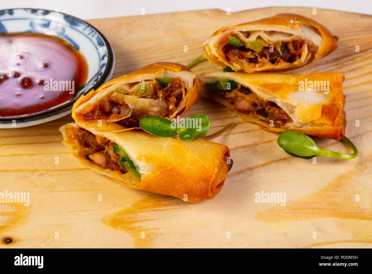 Spring roll with sauce over wooden Stock Photo - Alamy