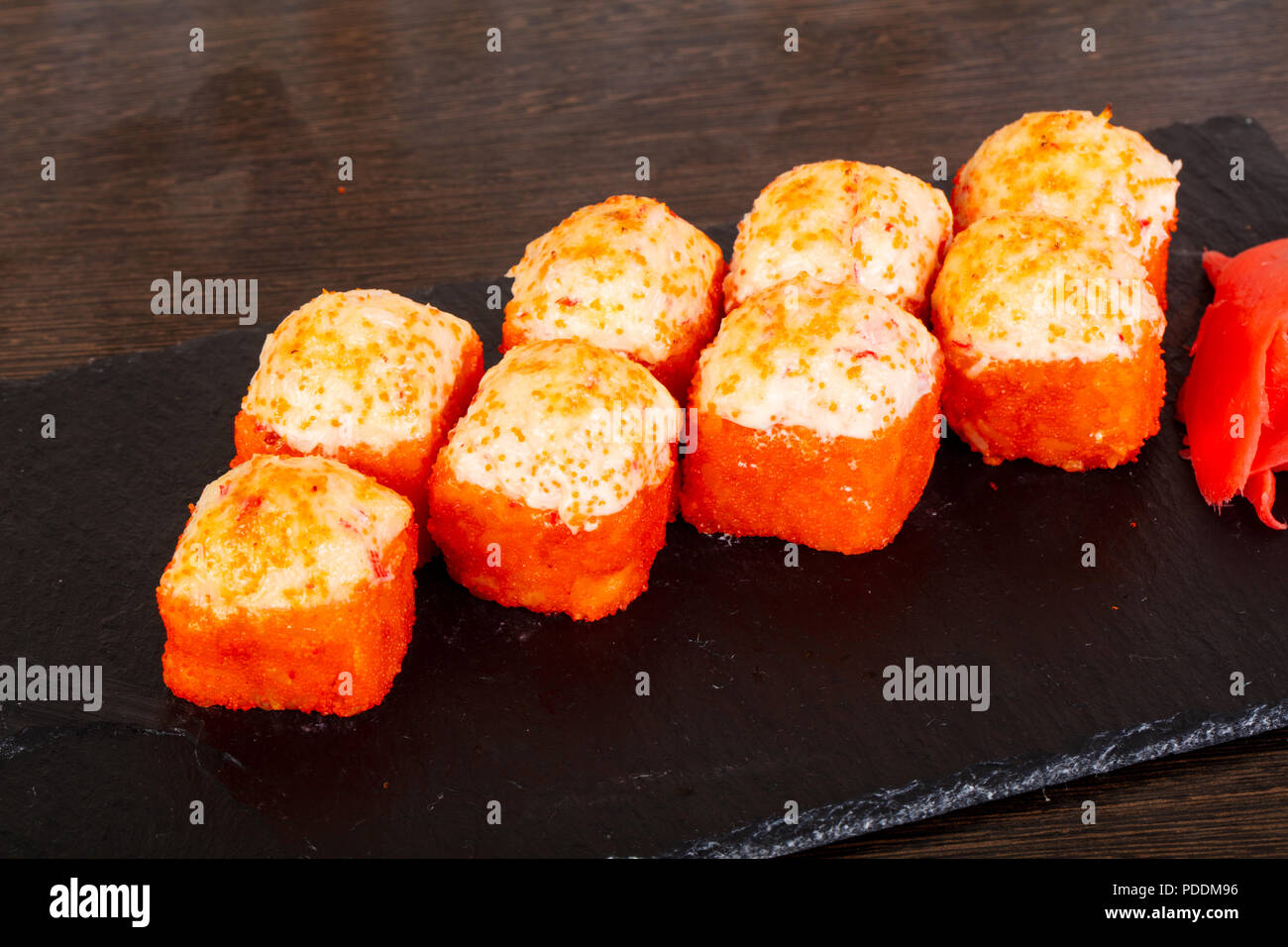 Delicious sushi roll with fried cheese Stock Photo - Alamy