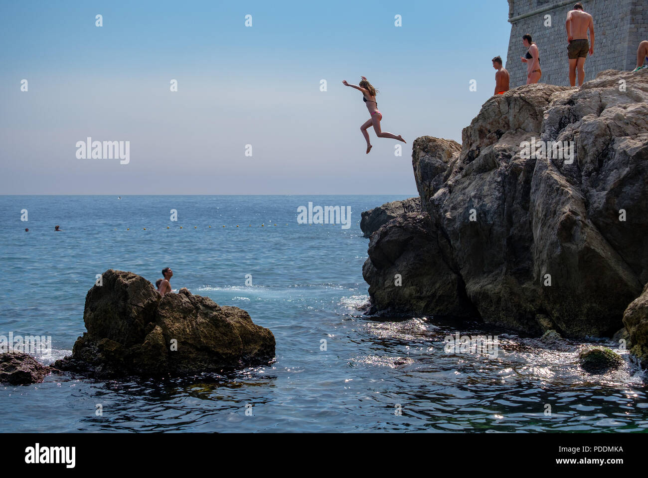 People jumping off a cliff to the Adriatic sea in Dubrovnik, Croatia ...