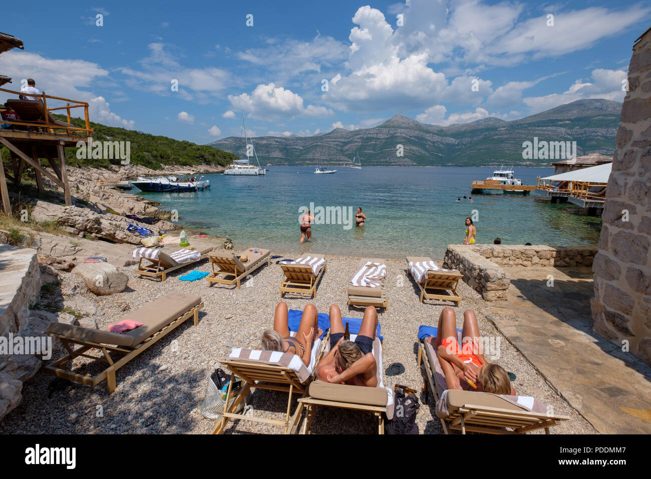 People sunbathing at the beach on the island of Sipan, Elafiti Islands ...