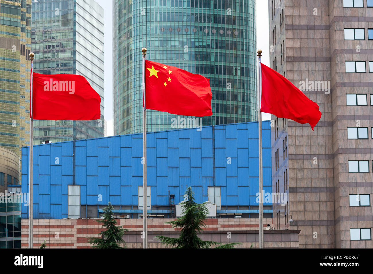 Chinese national flag flying between two red flags in pudong, Shanghai ...