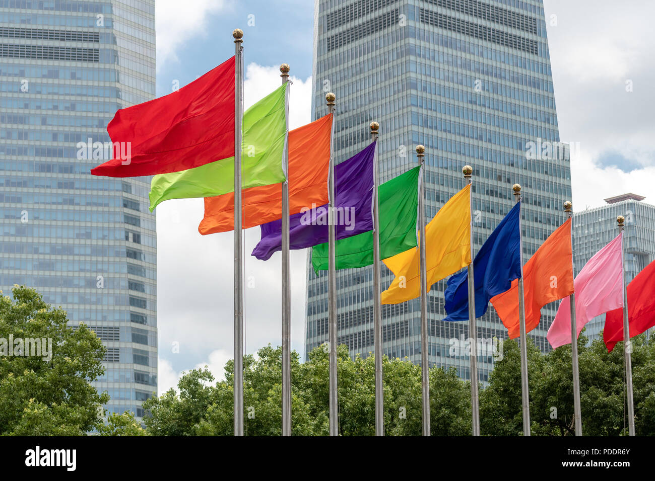 Various single-colour flags flying from a row of flag poles in Shanghai ...