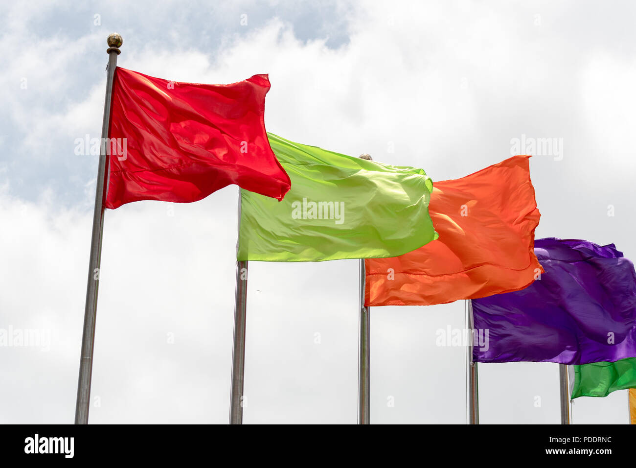 Various single-colour flags flying from a row of flag poles in Shanghai ...
