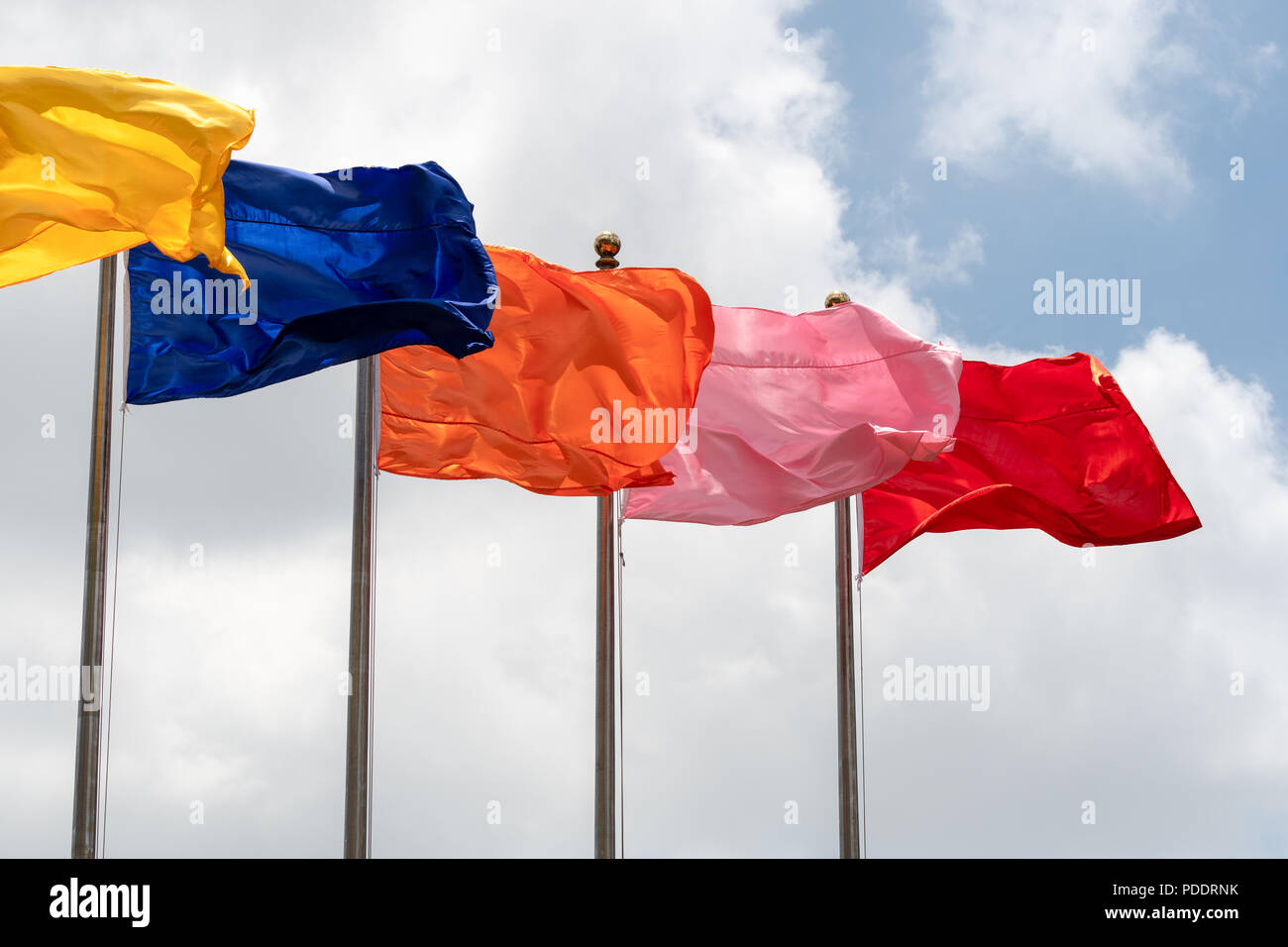 Various single-colour flags flying from a row of flag poles in Shanghai ...