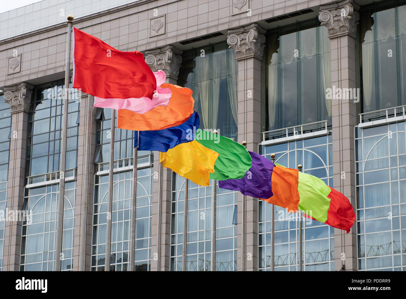 Various single-colour flags flying from a row of flag poles in Shanghai ...