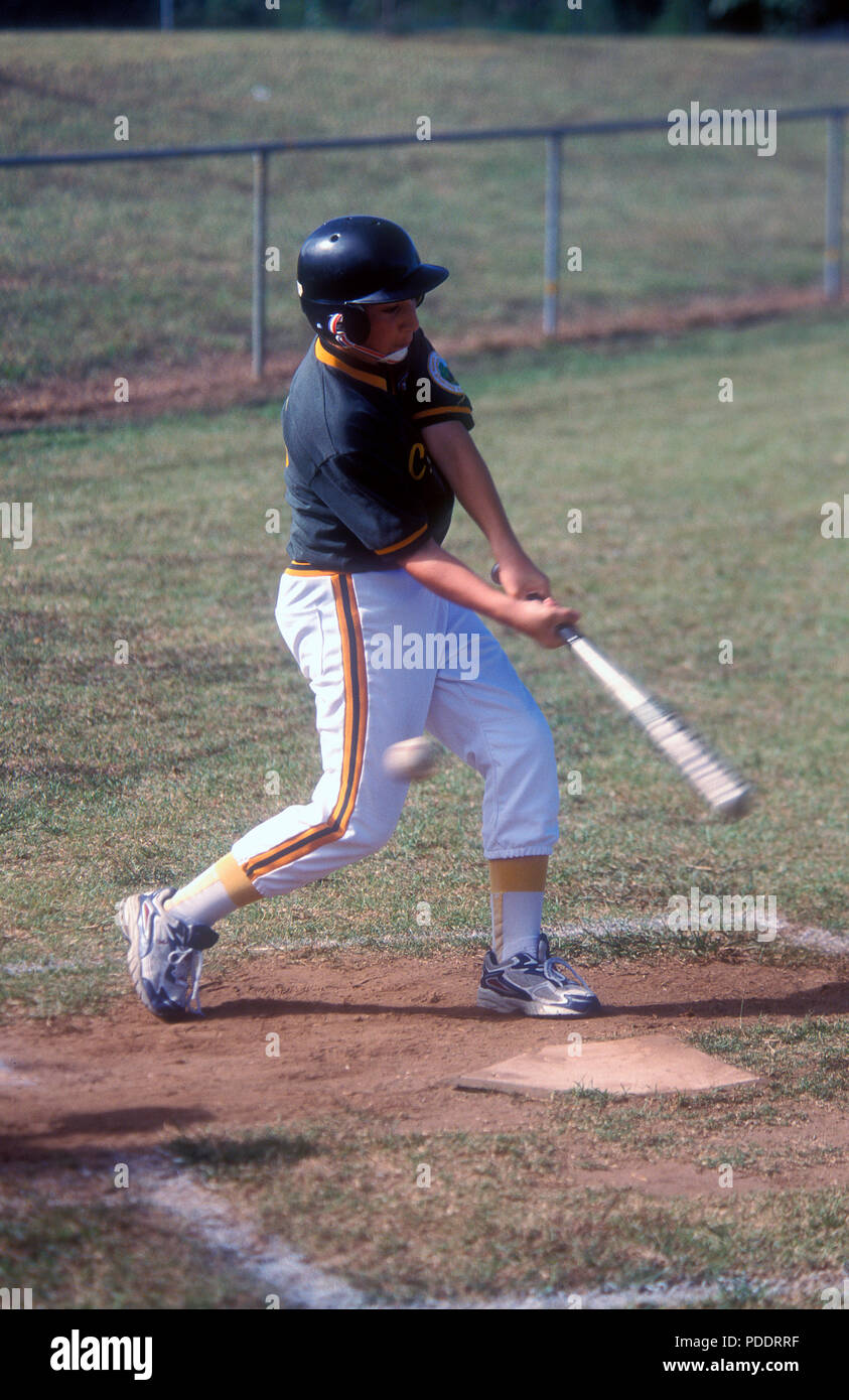 A YOUNG TEENAGE BOY STANDING AT THE PLATE ABOUT TO BAT AT A JUNIOR ...