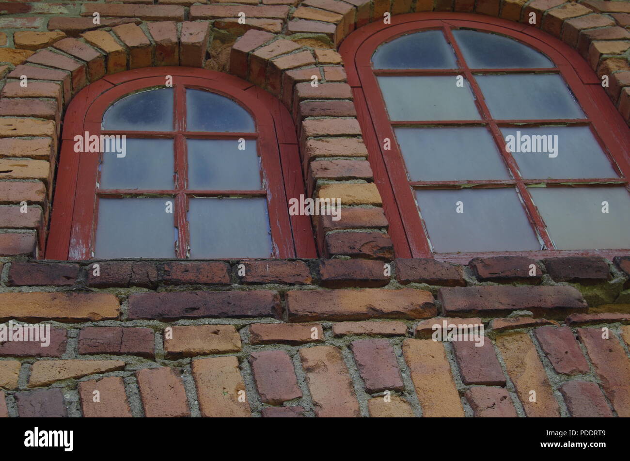 Arched windows in an old brick building Stock Photo - Alamy