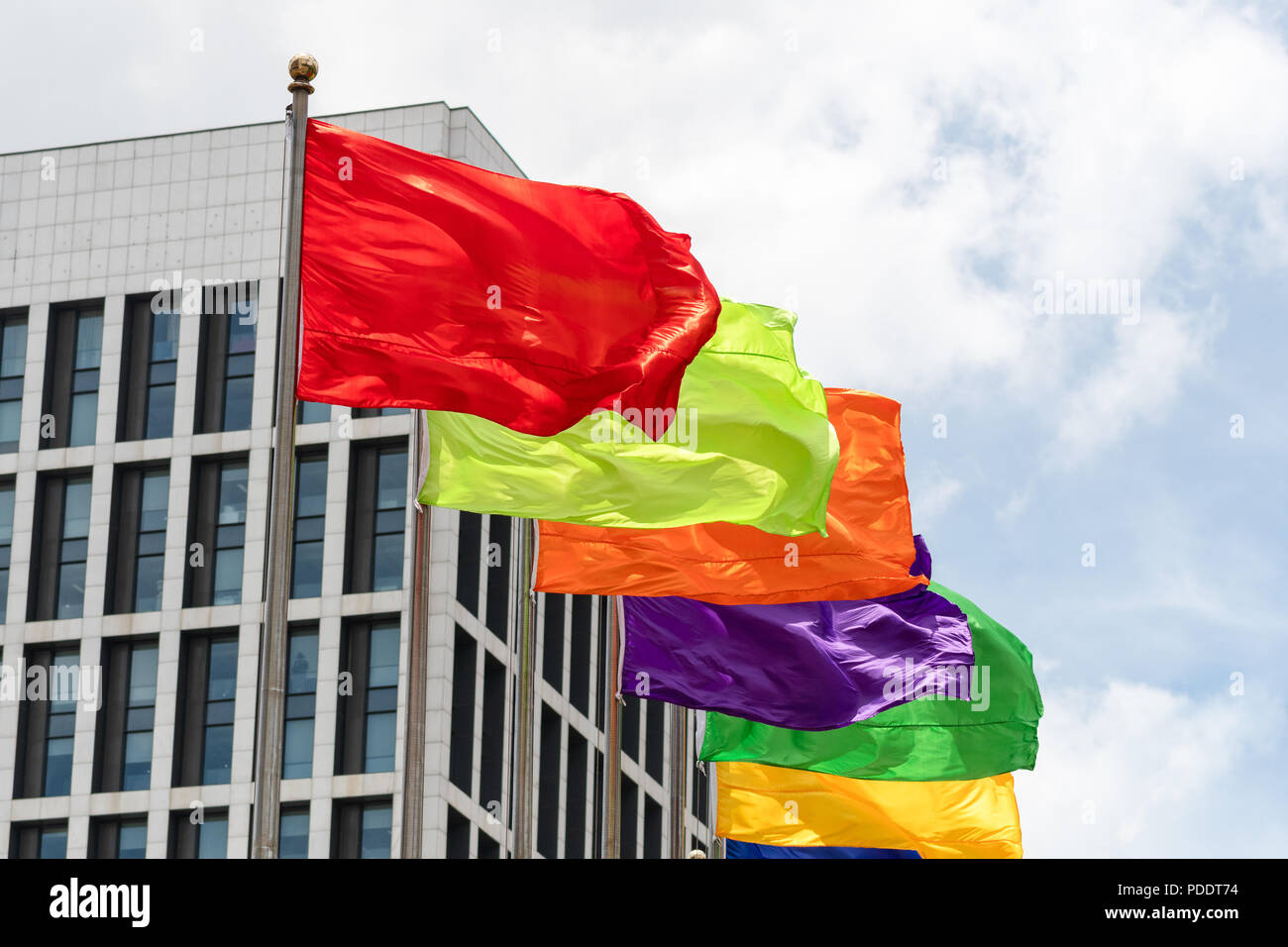 Various single-colour flags flying from a row of flag poles in Shanghai ...