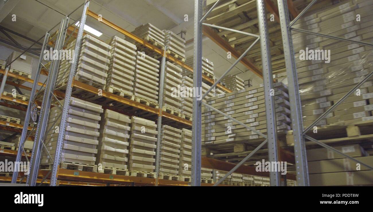 Boxes on high shelves at industrial warehouse on production plant drone ...