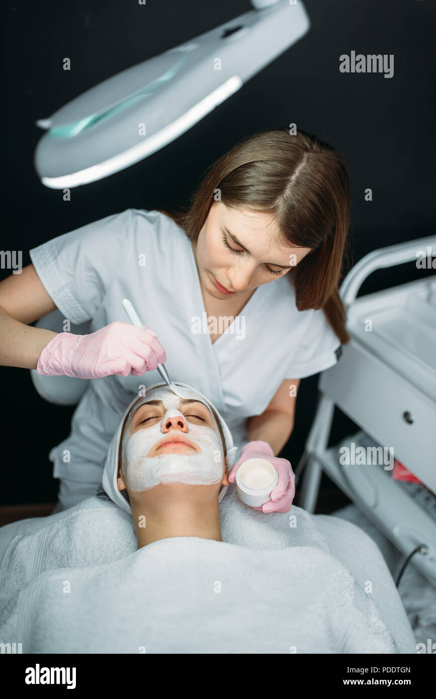 Female doctor holds cream and brush in hands Stock Photo - Alamy