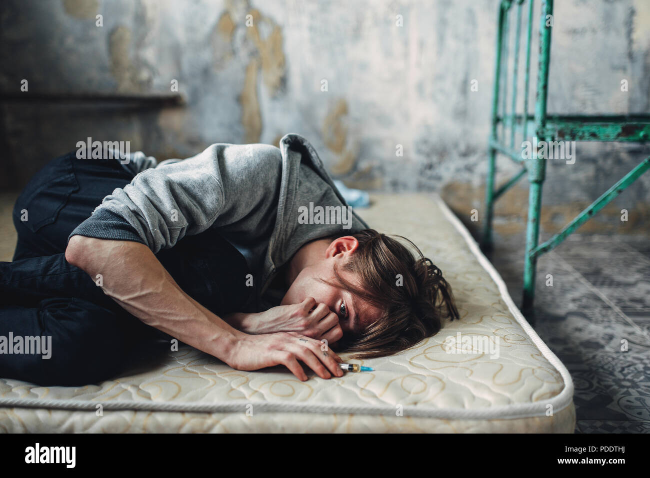 Male drug addict sleeping in bed after dose Stock Photo - Alamy