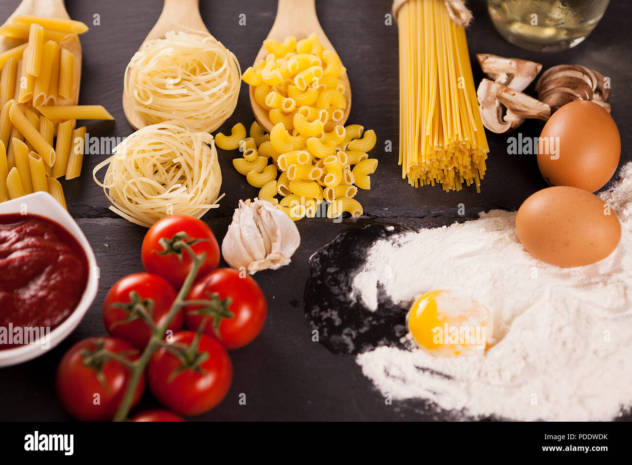 Variety mix of different pasta and macaroni next to healthy and ...