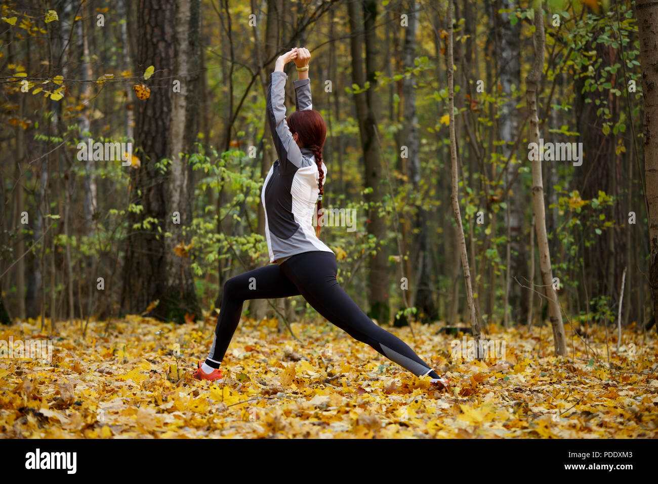 Photo of sporty fitness girl doing stretching exercises in fresh air ...