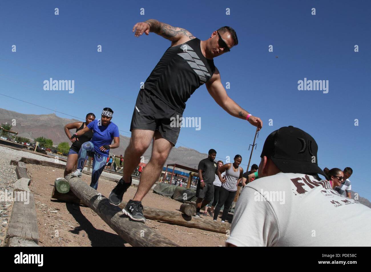 Participants maneuver over a log-crossing obstacle at the air assault ...