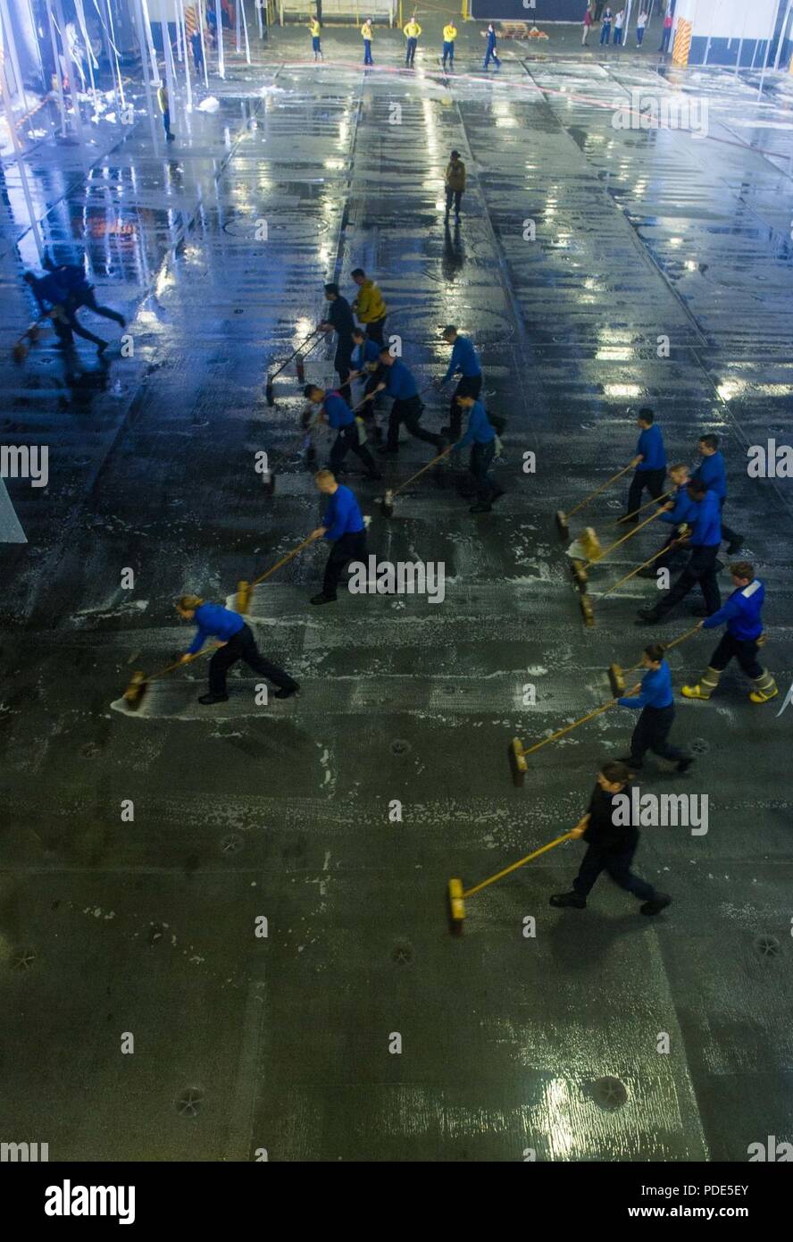 WATERS SOUTH OF JAPAN (May 13, 2018) Sailors perform a hangar bay scrub ...