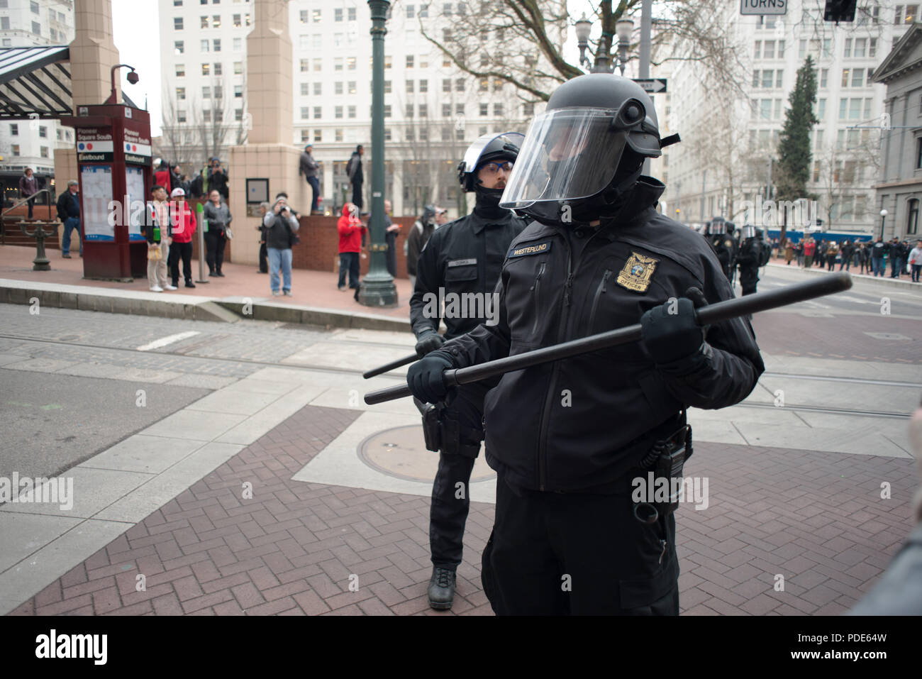 A police officer in riot gear after clearing the roadway of protesters ...
