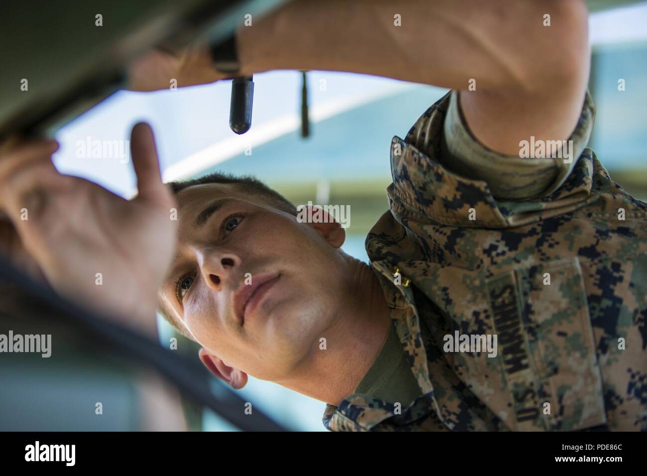 U.S. Marine Corps Sgt. Iain J. Fouts sets up a very small aperture ...