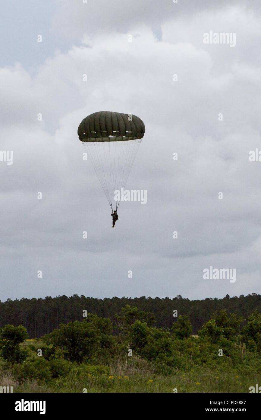 A British Commando parachutes from a CH-53E Super Stallion after ...