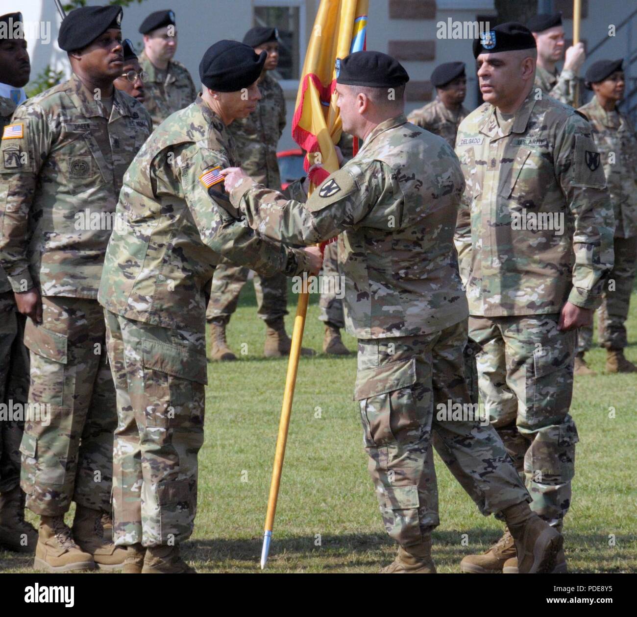 Maj. Gen. Steven A. Shapiro, 21st TSC commanding general, hands Command Sgt. Maj. Rocky Carr ...