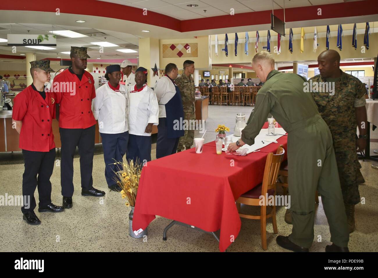 Teams of chefs await the judge’s decision during the quarterly cook off ...