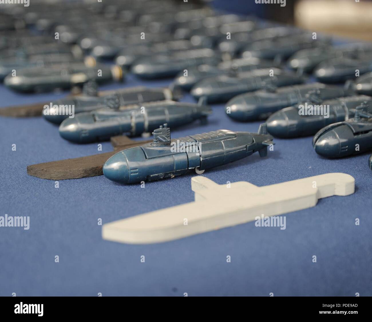 Small submarines, representing 52 submarines lost, rest on a table ...