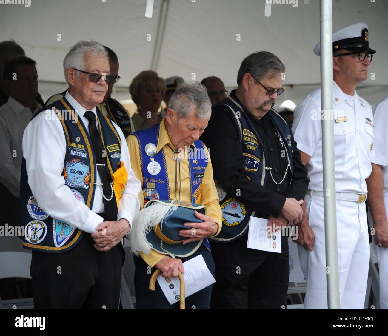 Submarine veterans, active duty submariners, family and friends stand ...