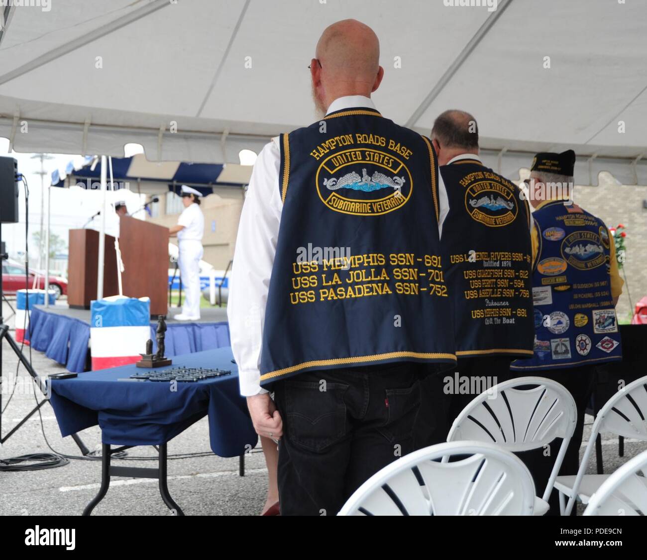 Submarine veterans, active duty submariners, family and friends stand ...