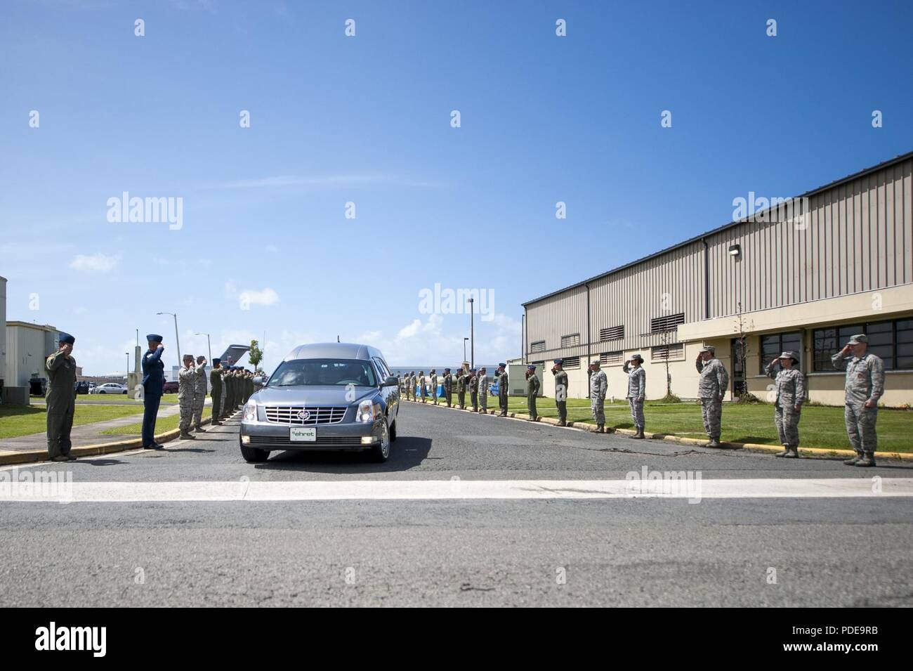 A hearse leaves Muñiz Air National Guard Base following a Dignified ...