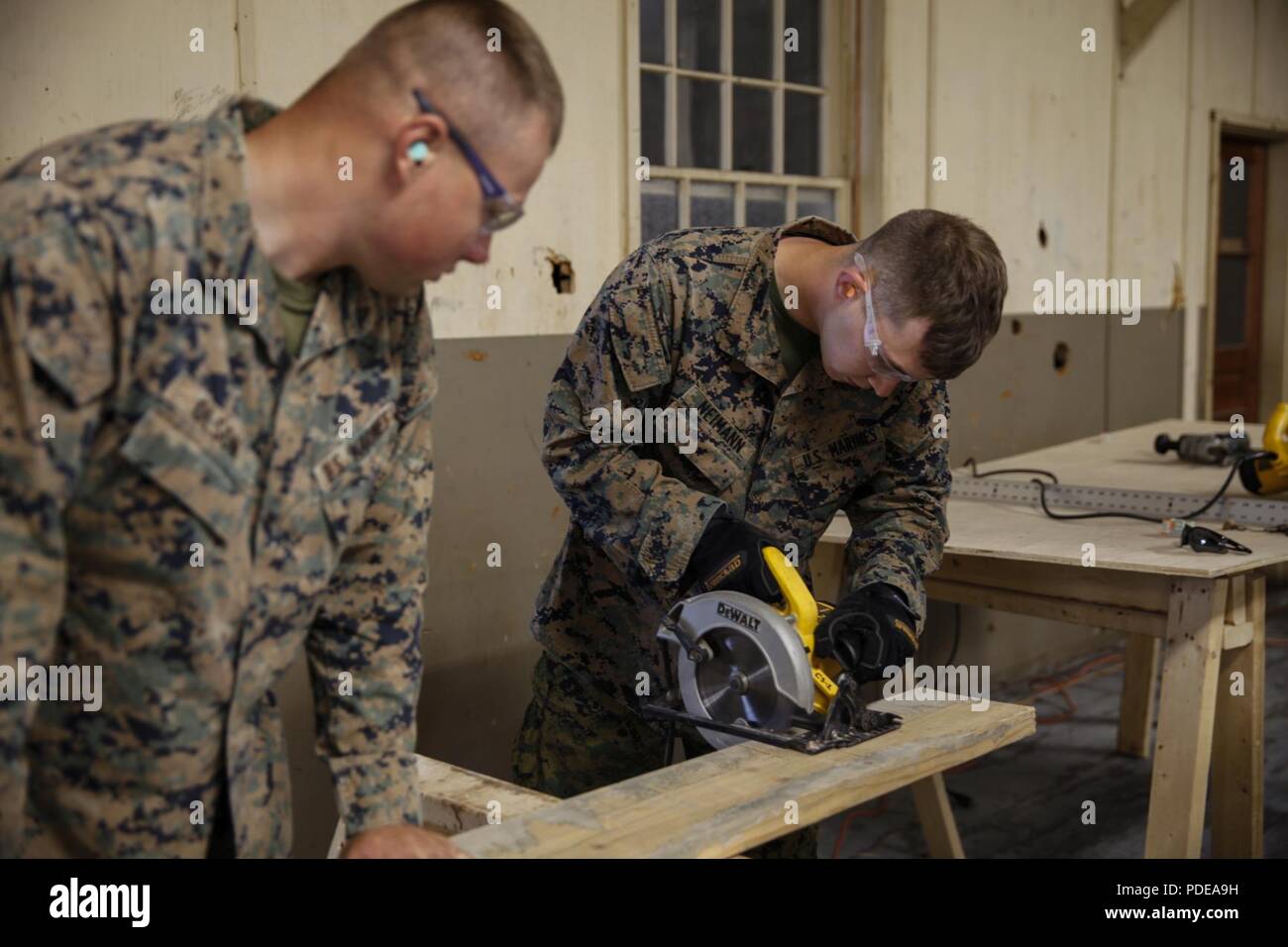 U.S. Marine Lance Cpl. Mitchell R. Neimann (right), heavy equipment ...