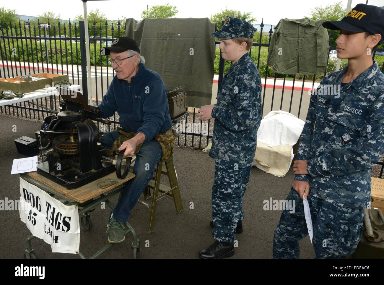 Rowdie Tamblyn makes dog tags for U.S. Navy Sea Cadet members during ...