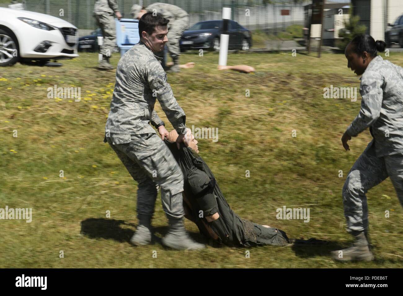 Airmen drag a mannequin while competing in the combat readiness relay ...