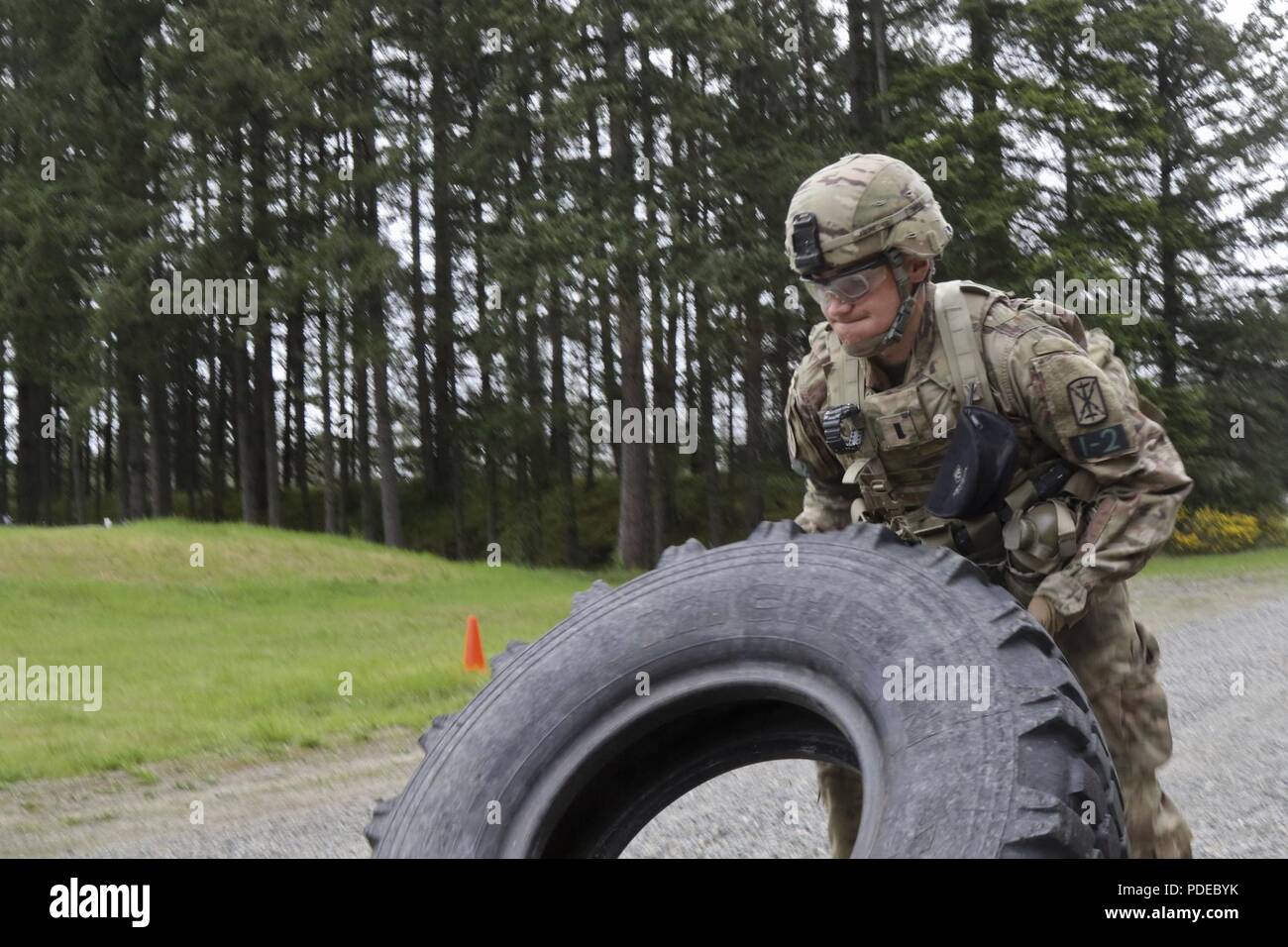 1st Lt. Ryan Perez from 17th Field Artillery Brigade flips a tire for ...