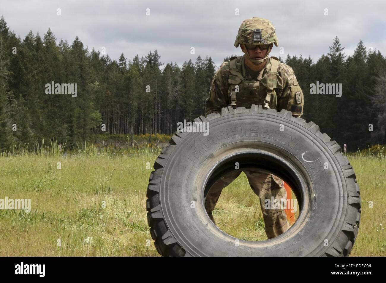 1st Sgt. Scott Kelsey from 17th Field Artillery Brigade flips a tire ...
