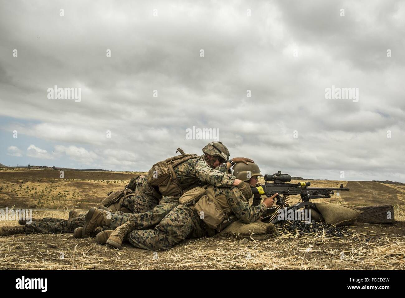 U.S. Marines attending Marine Combat Training (MCT) fire an M240B ...