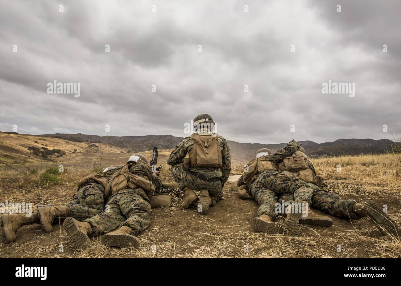 U.S. Marines attending Marine Combat Training (MCT) fire an M240B ...