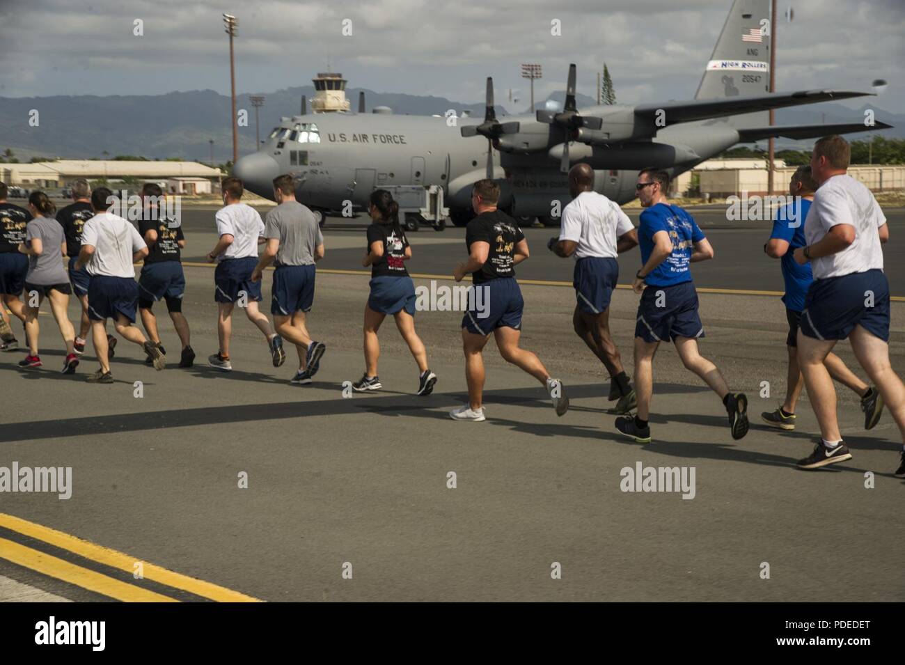 Airmen from 515th Air Mobility Operations Wing run in formation during ...