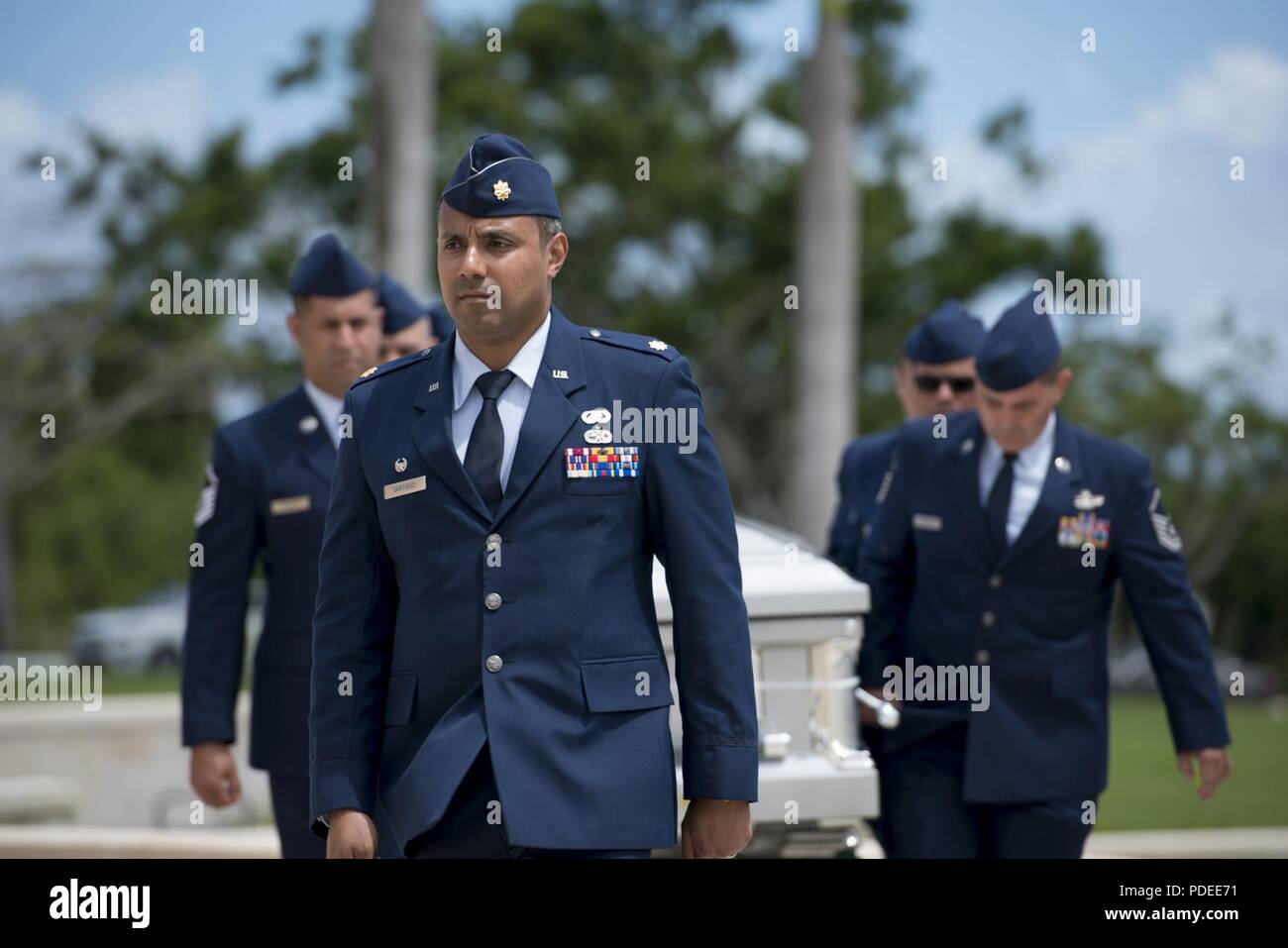 Maj. Alexander Santiago leads pallbearers carrying the casket of Master ...