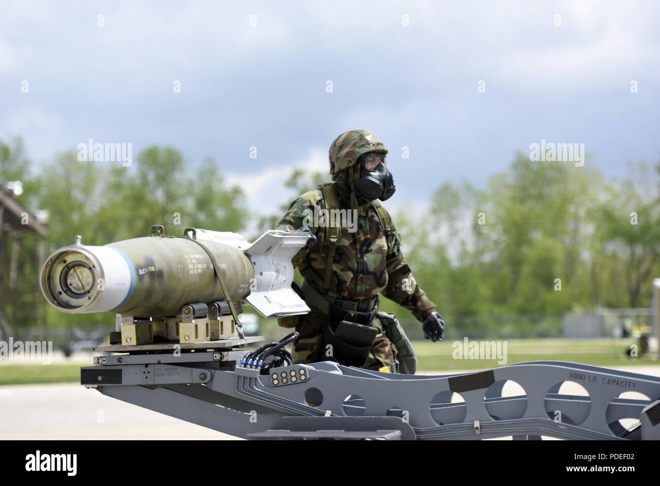 Airman with the 180th Fighter Wing maintenance group uses a bomb lift ...