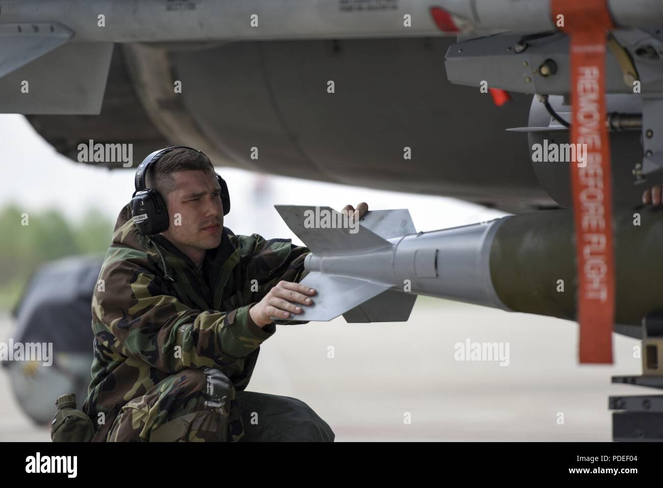 Airman with the 180th Fighter Wing maintenance group uses a bomb lift ...