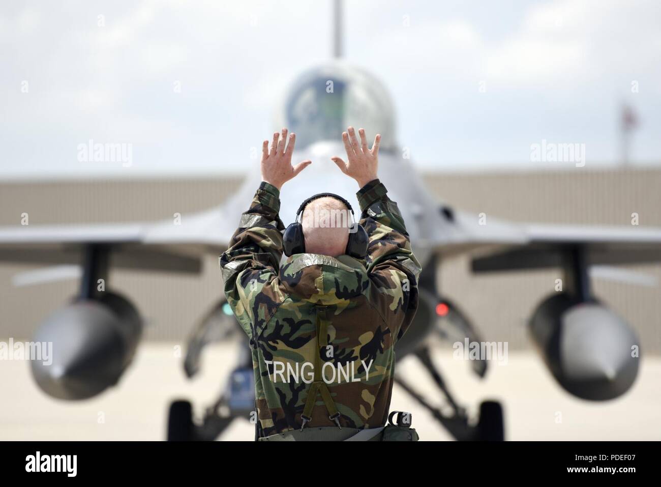Airman with the 180th Fighter Wing maintenance group uses hand signals ...