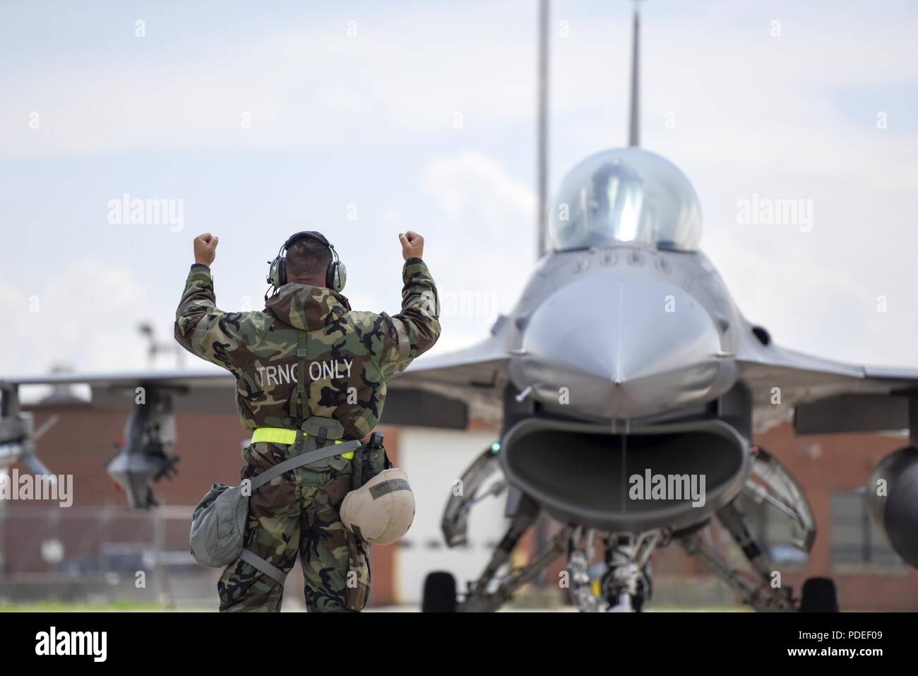 Airman with the 180th Fighter Wing maintenance group uses hand signals ...