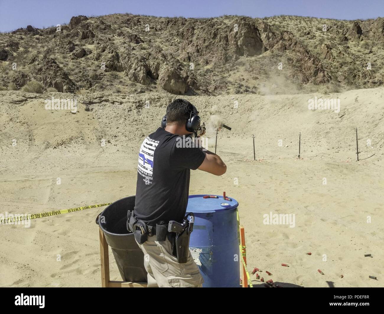 Corporal Cristobal Perez, police officer, fires the M1014 shotgun ...