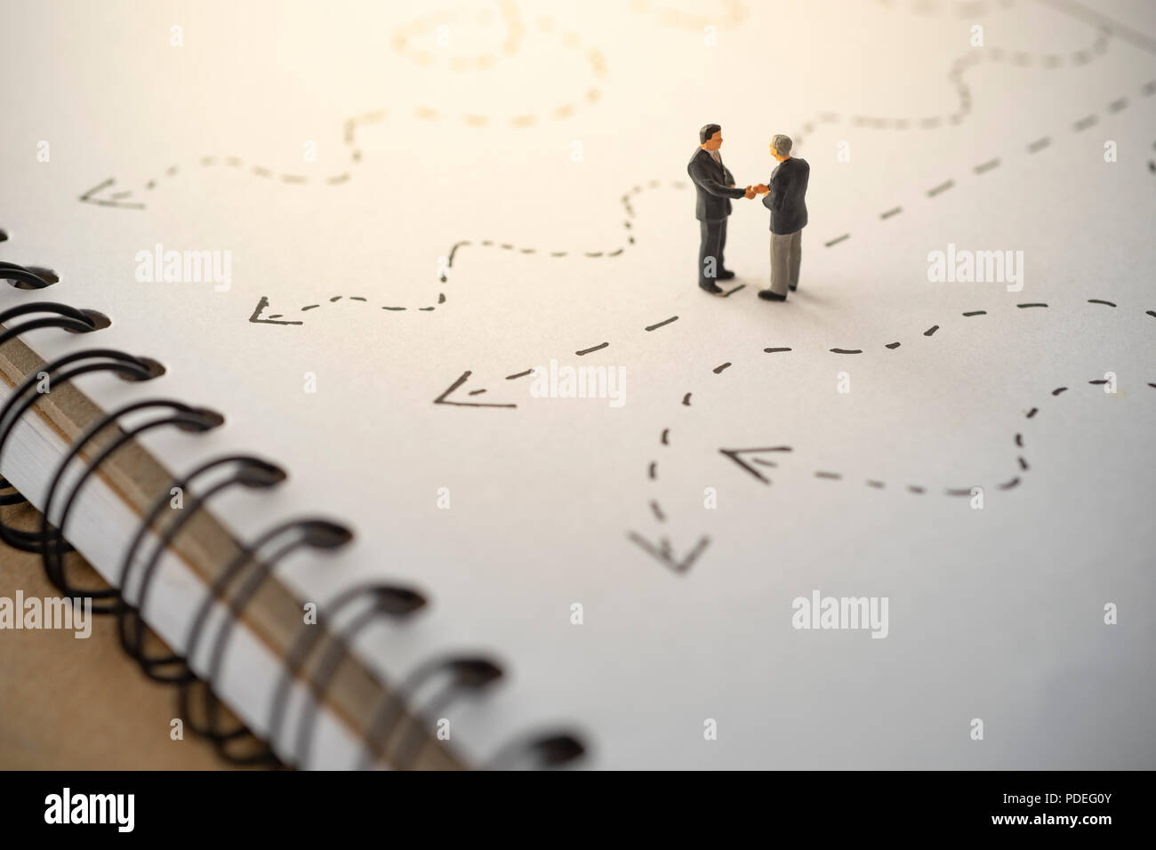 Business decision concept. Businessmen doing hand shake with many arrow ...