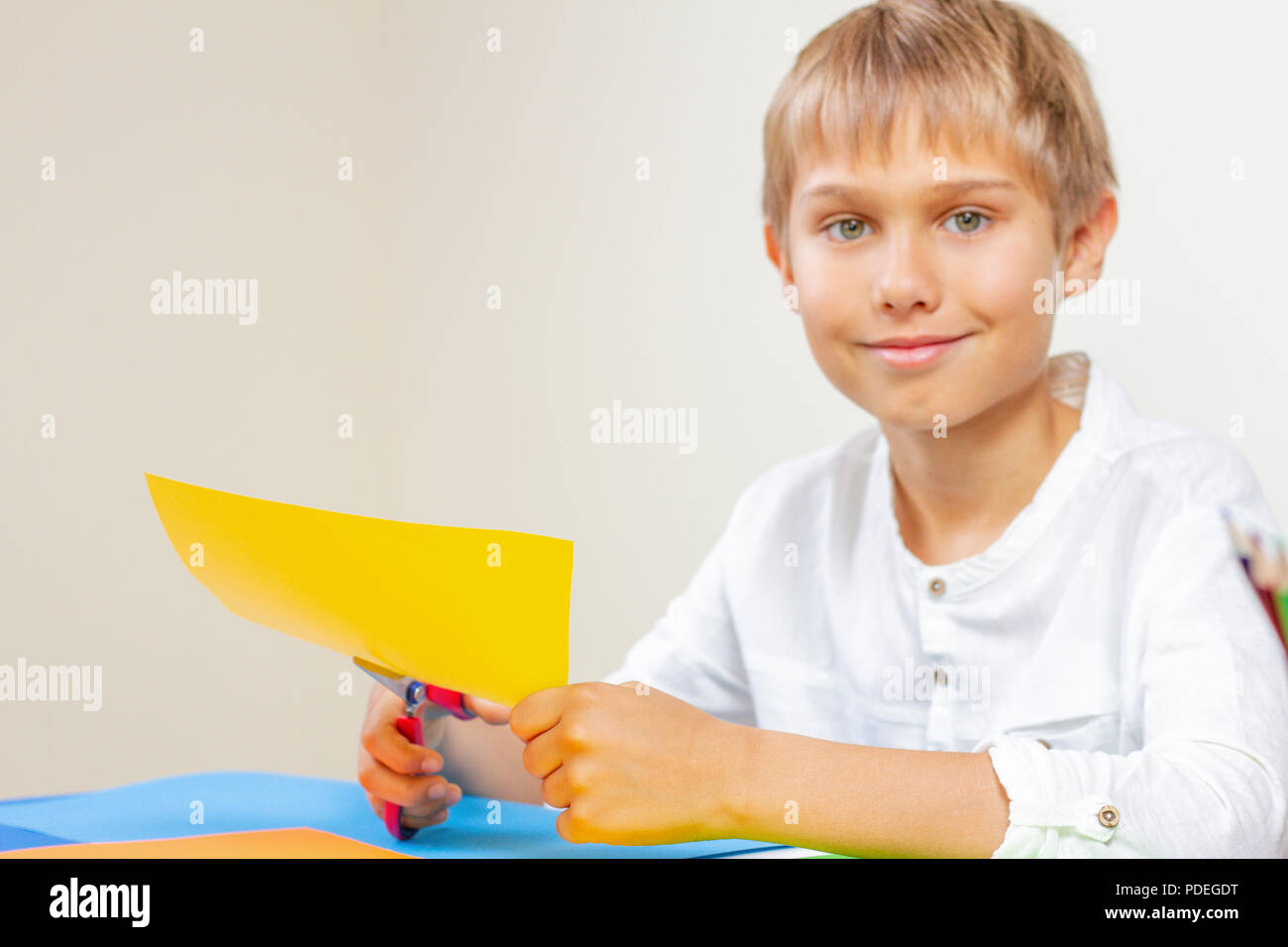 Elementary boy cutting paper scissors hi-res stock photography and ...