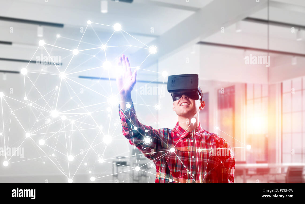 Guy wearing checked shirt and virtual mask reaching hand to touch ...