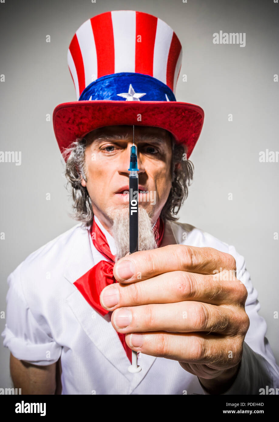 Uncle Sam holding up a syringe labeled oil. Concept of addicted to oil ...