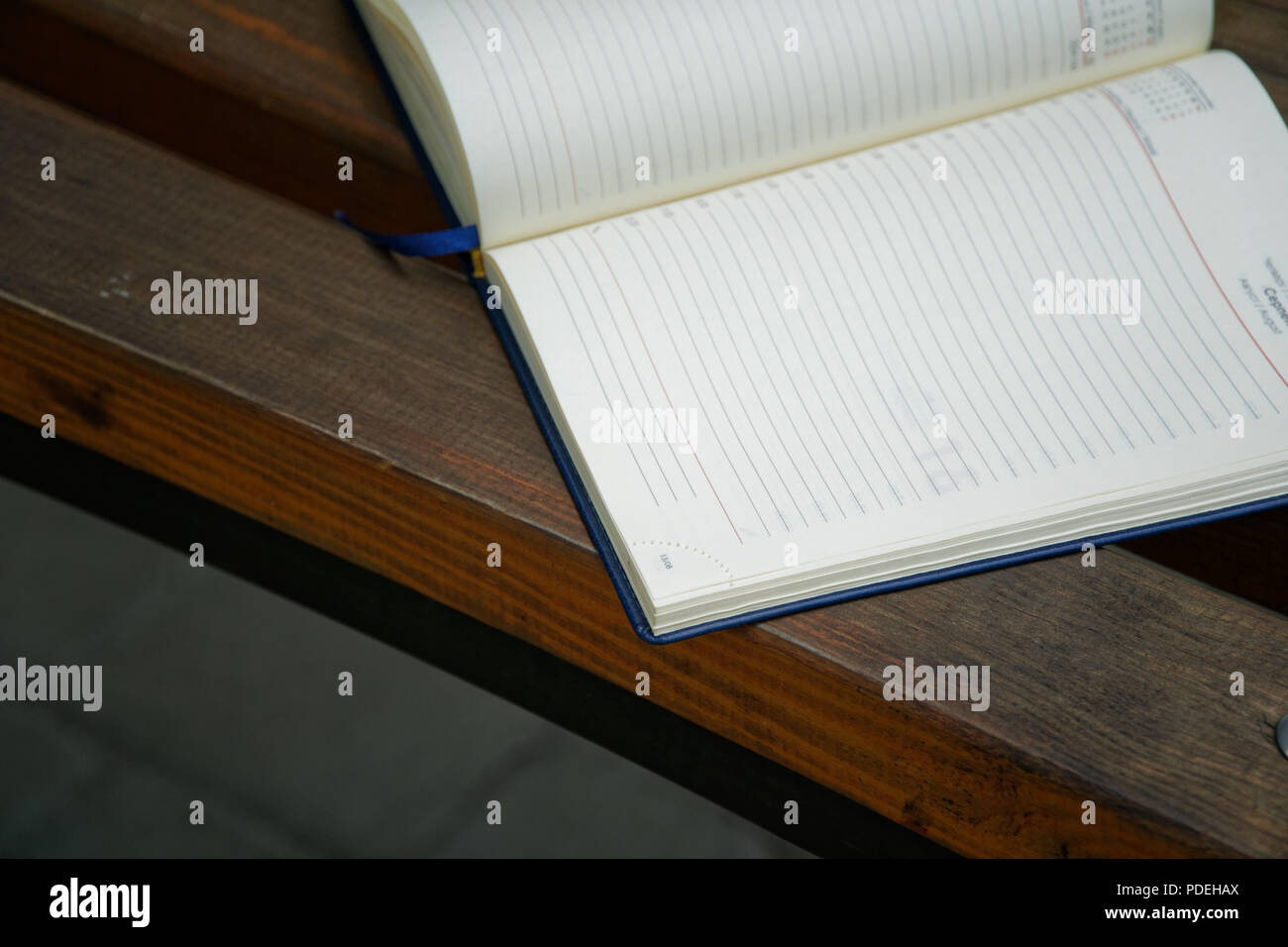 Open Notebook lies bench in park, business concept Stock Photo - Alamy