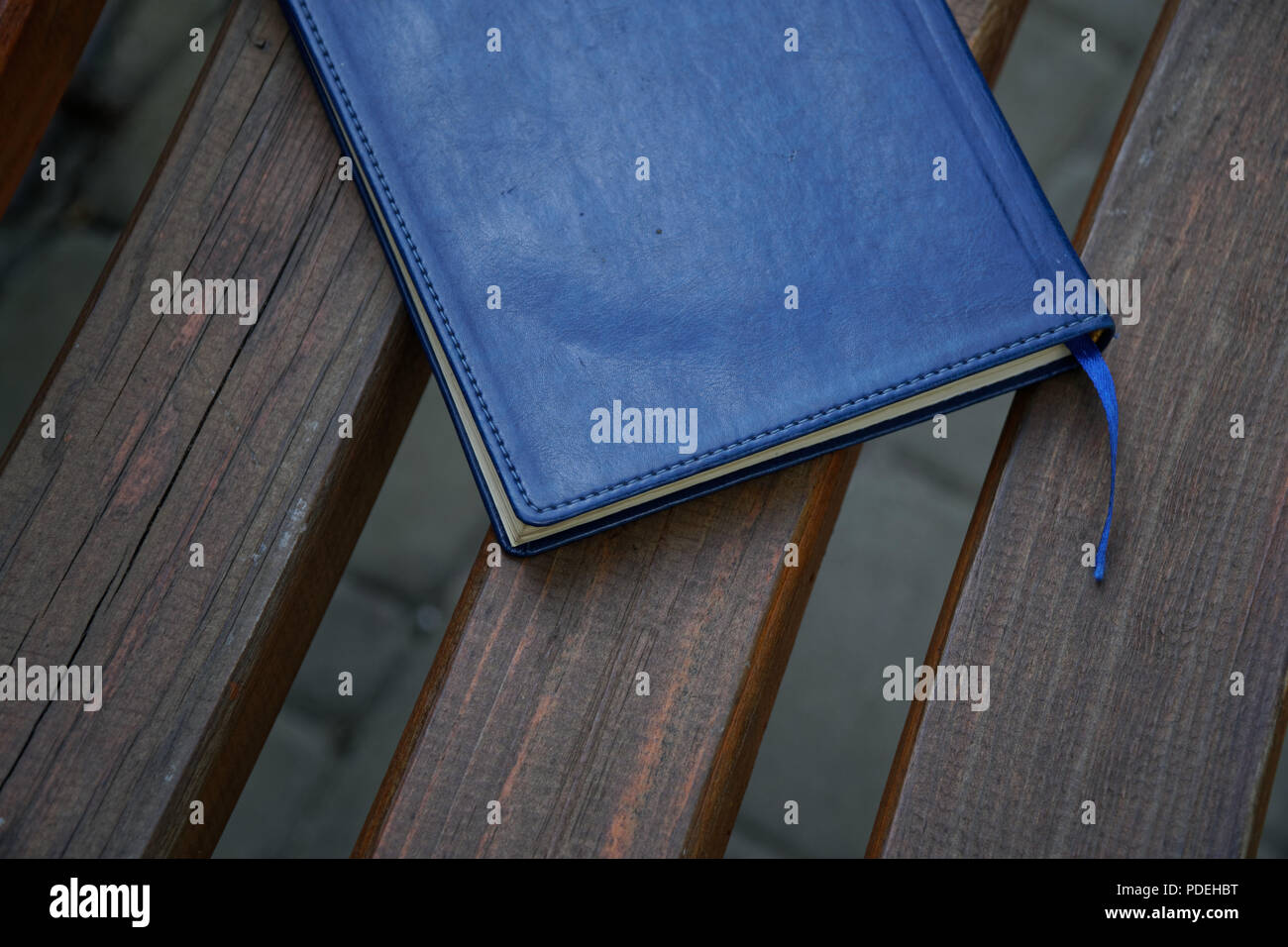 Notebook on bench in park, business concept Stock Photo - Alamy