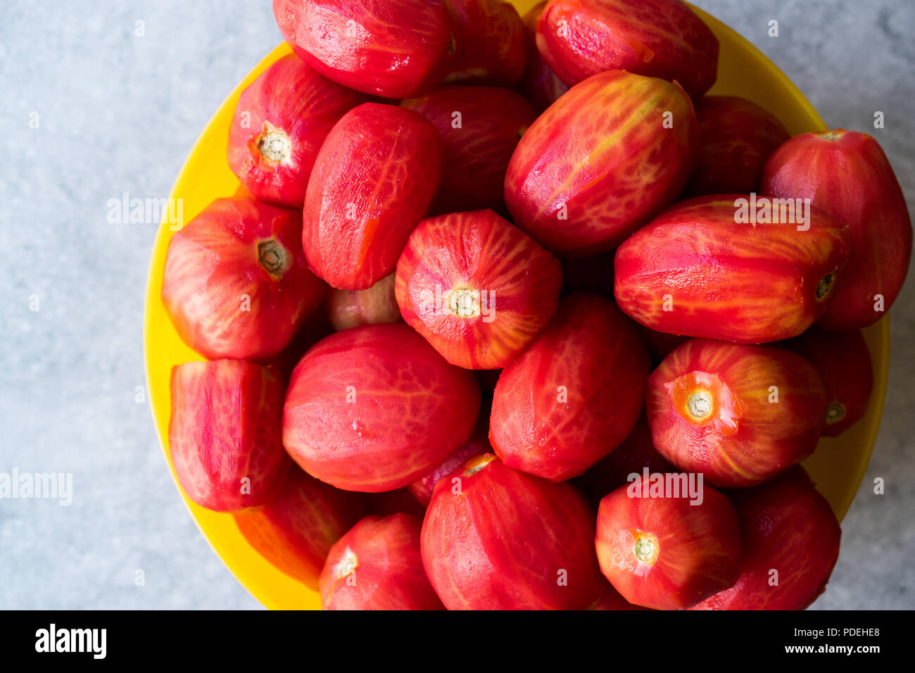 Whole Peeled Tomatoes in Yellow Bowl. Organic Food Stock Photo - Alamy