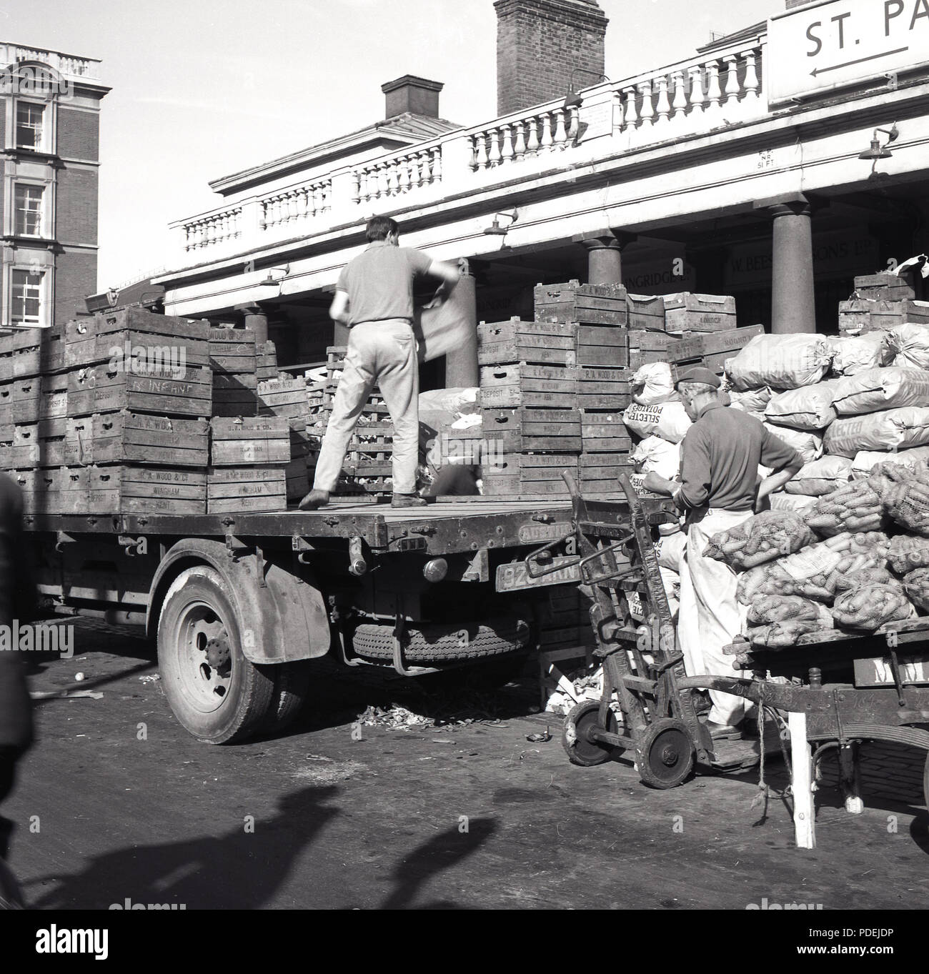 1950s, historical, traders unloading wooden crates of fruit and ...
